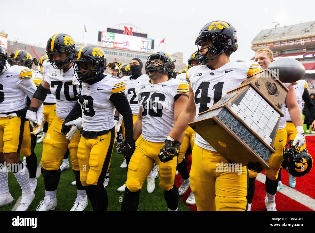 Iowa players hold hands as they leave the field with the Heroes Game ...