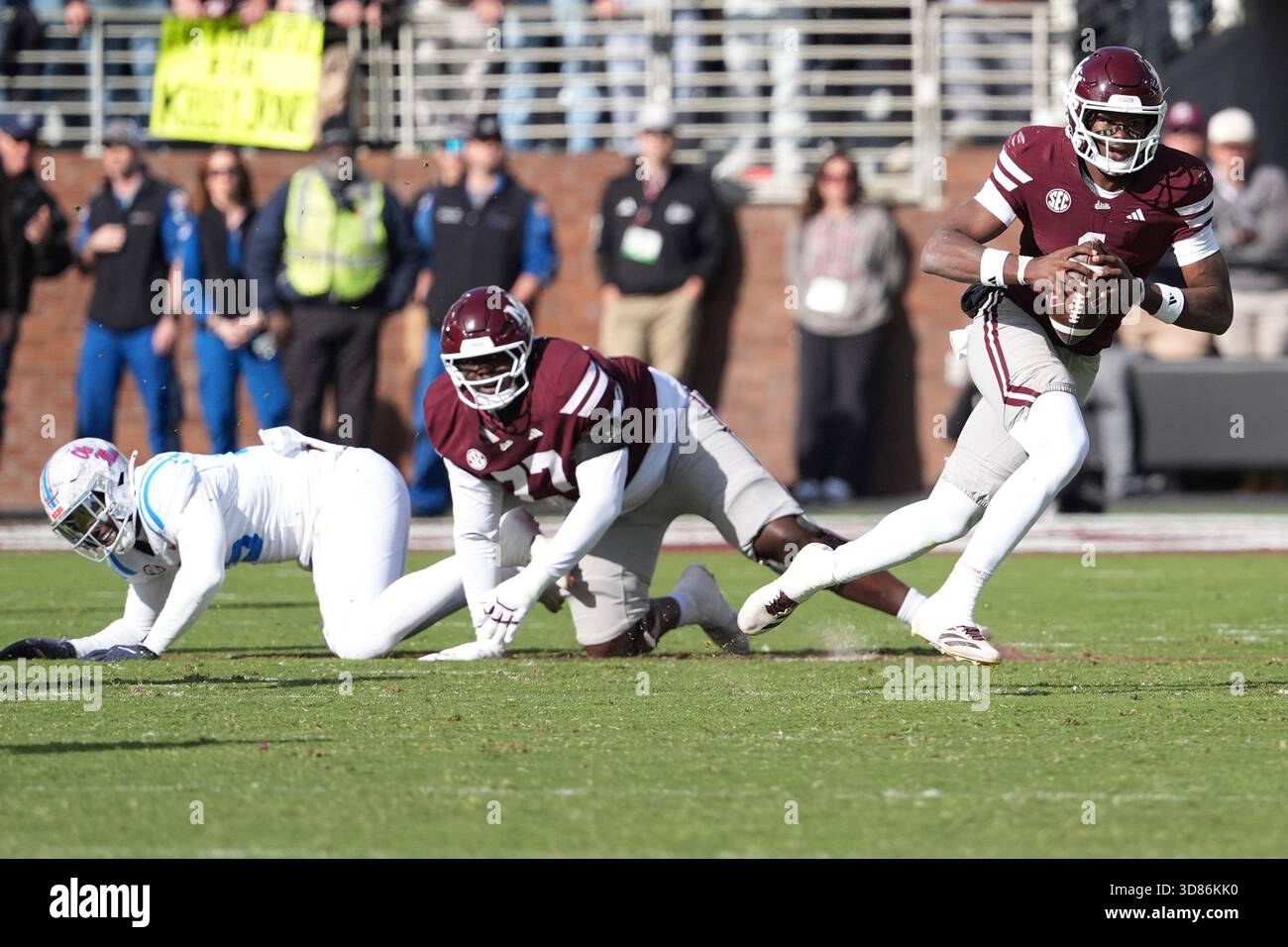 Mississippi State quarterback Kamario Taylor, right, evades a sack ...