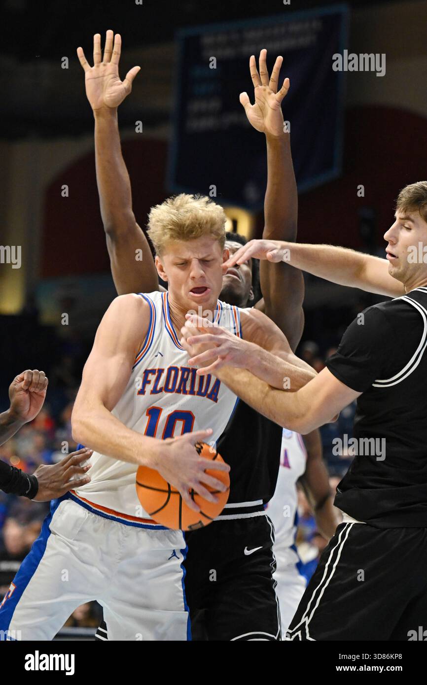 Florida forward Thomas Haugh (10) fights for the ball with Providence ...