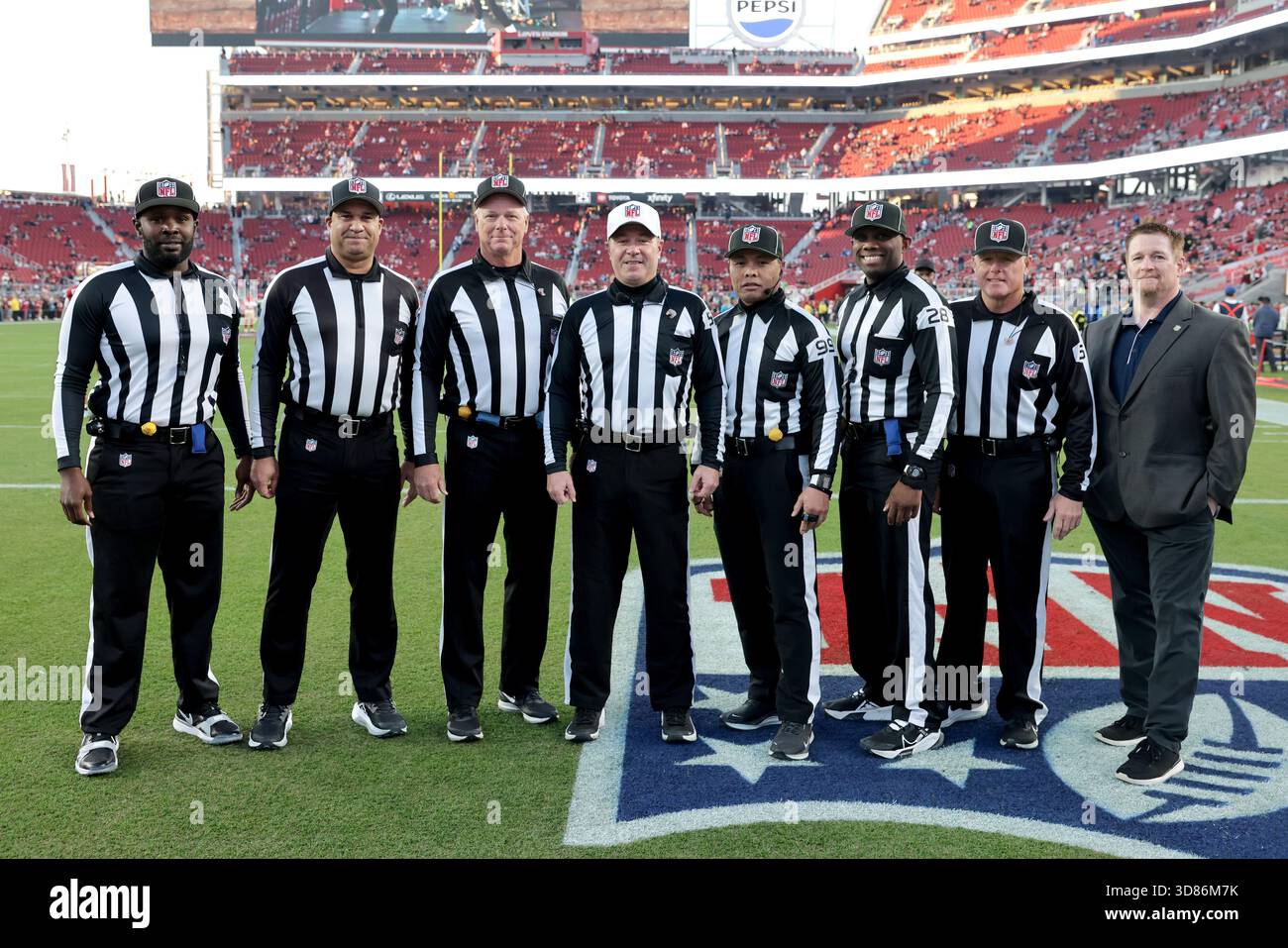 Officiating crew members Umpire Brandon Ellison (128), down judge Mike ...