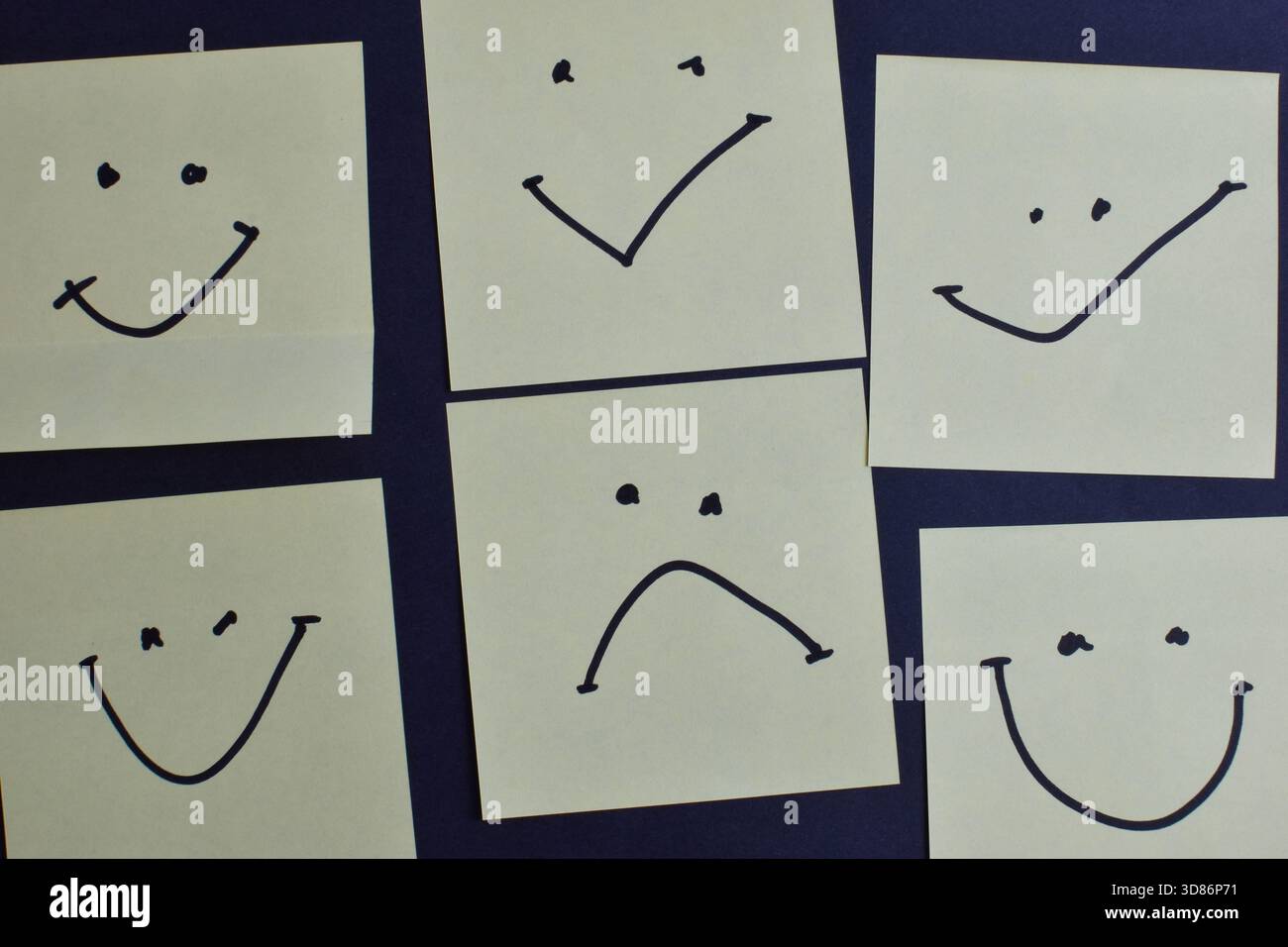 Six sticky notes with varied facial expressions on dark background ...