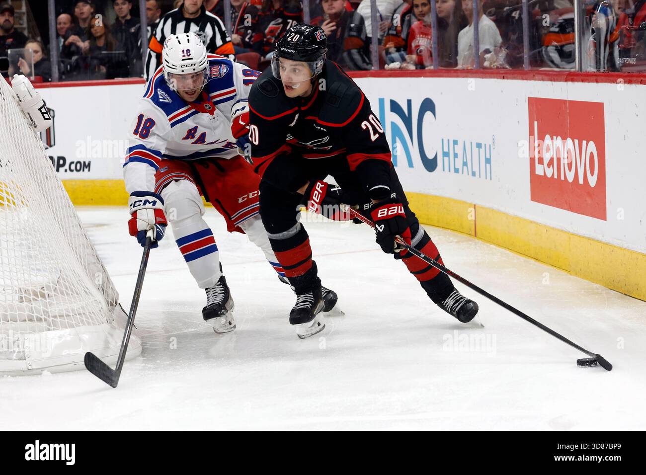 Carolina Hurricanes' Sebastian Aho (20) controls the puck New York Rangers' Urho Vaakanainen (18 ...