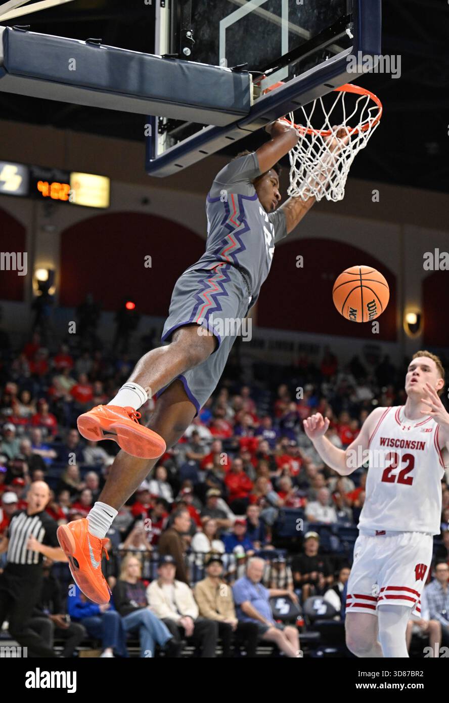 TCU forward Xavier Edmonds dunks as Wisconsin guard Andrew Rohde looks ...
