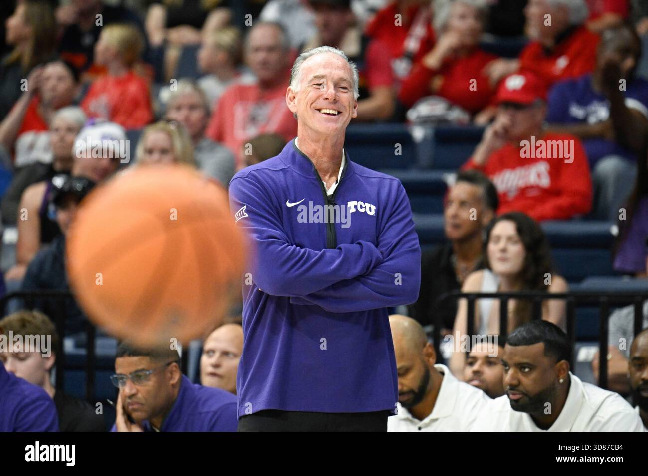 TCU head coach Jamie Dixon smiles as he looks on during the first half ...