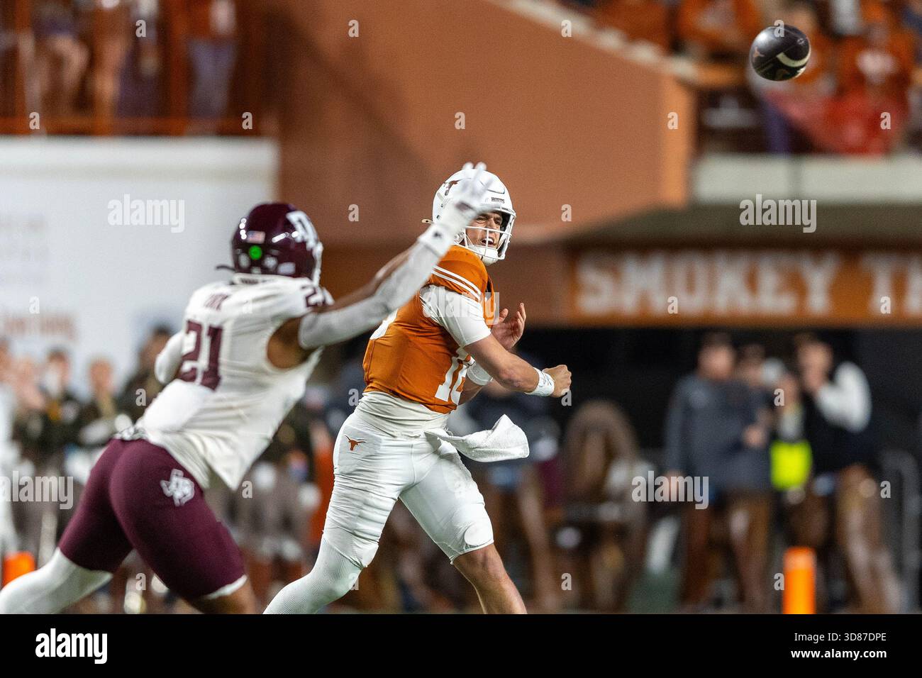 Texas quarterback Arch Manning, right, throws past Texas A&M linebacker ...