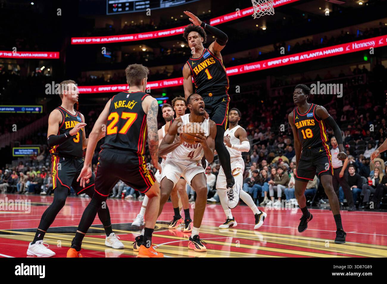 Cleveland Cavaliers center Evan Mobley (4), center-bottom, attempts a ...
