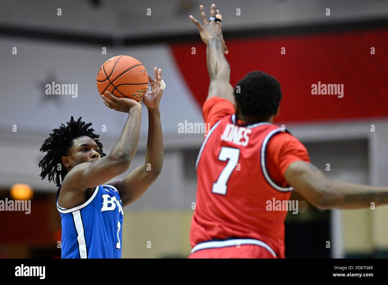 BYU guard Robert Wright III, left, goes up to shoot in front of Dayton ...