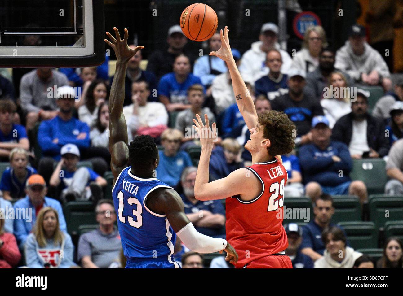 Dayton forward Amael L'Etang (29) shoots in front of BYU center Keba ...