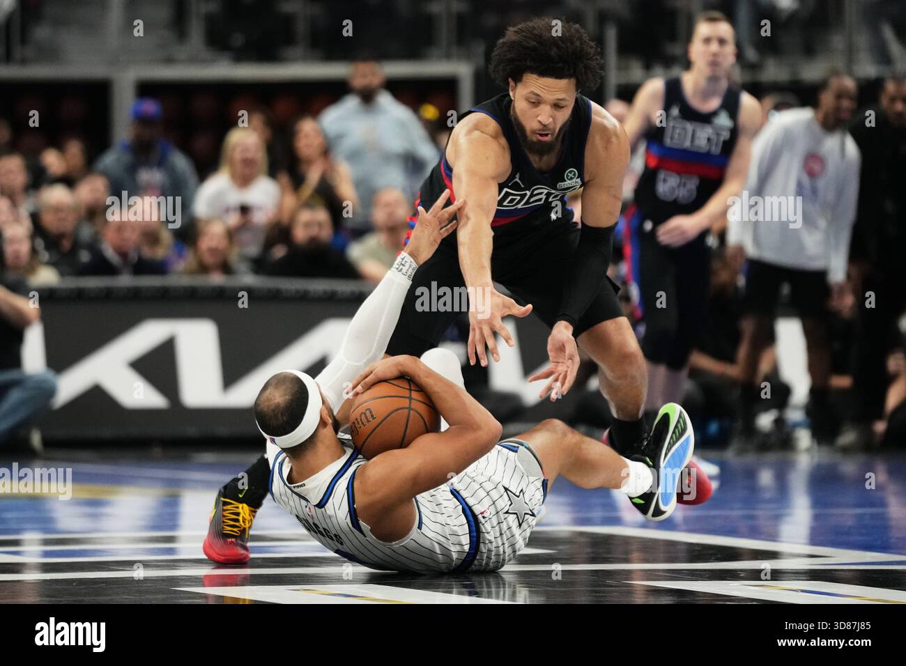 Detroit Pistons guard Cade Cunningham, right, and Orlando Magic guard ...