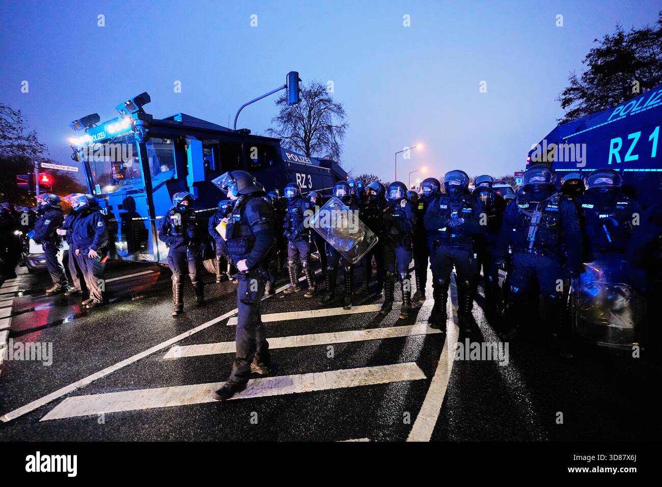 German police officers stand next to a water canon during a ...