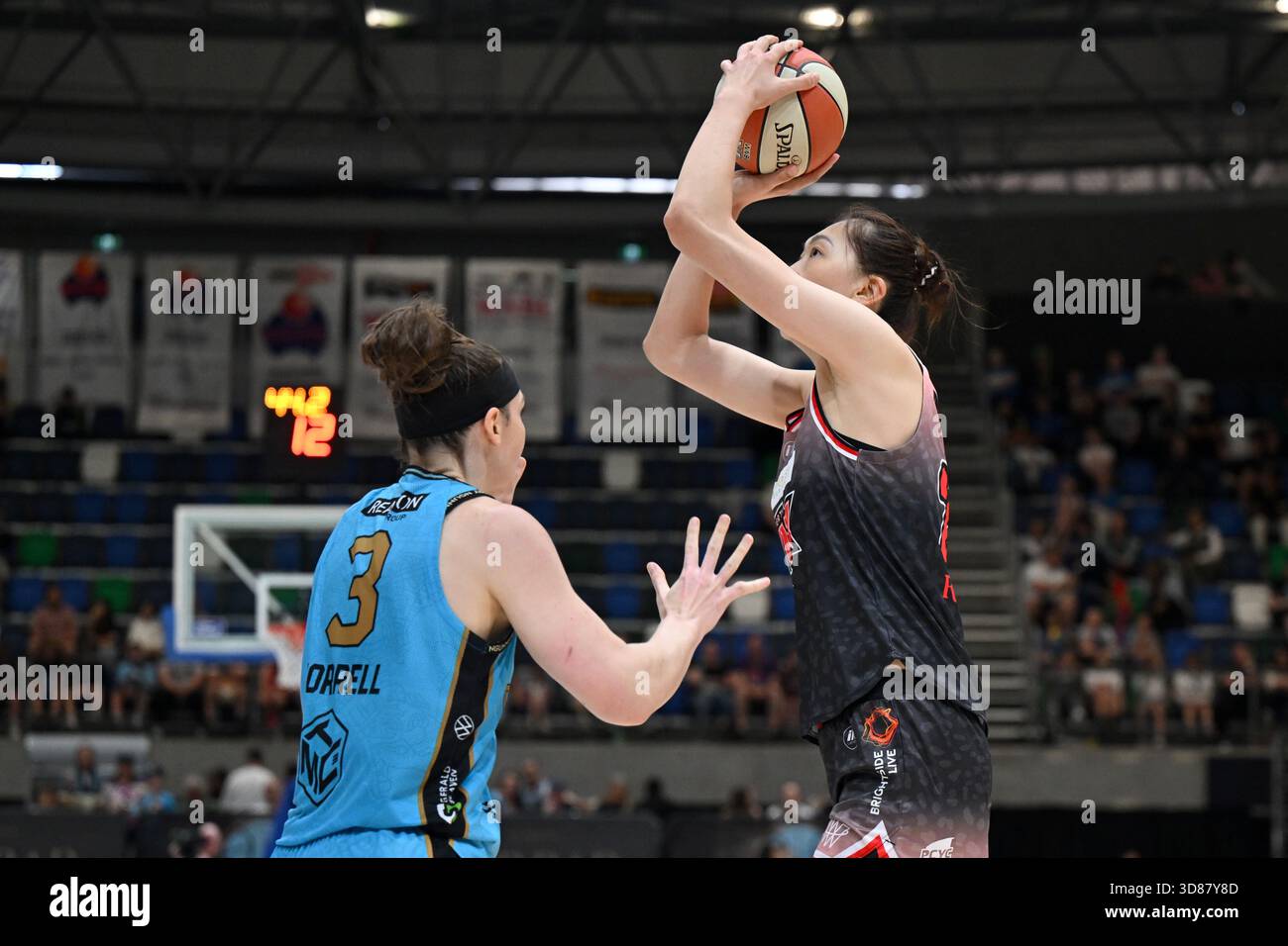 Han Xu of Perth Lynx is challenged by Teige Morrell of the Capitals ...