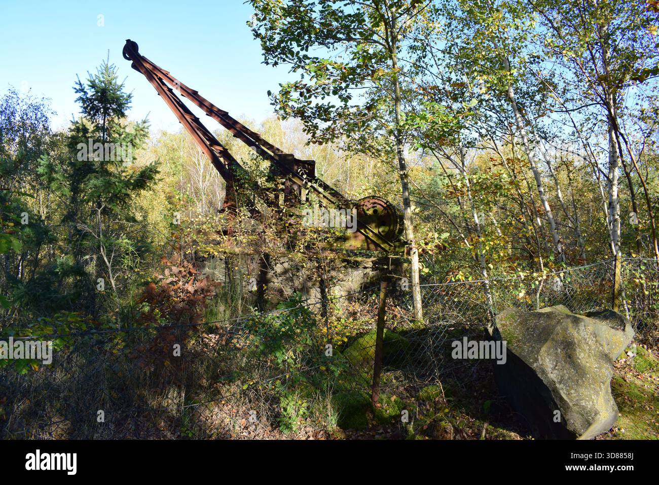 rusty old quarry crane remains in the autumn forest Stock Photo - Alamy