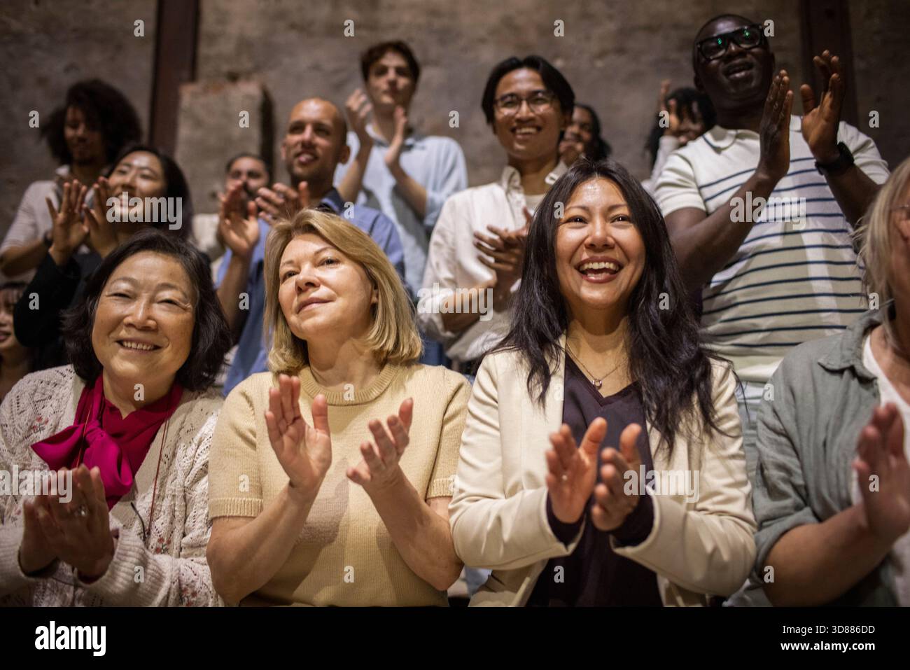 Happy women clapping while watching play in theater Stock Photo - Alamy