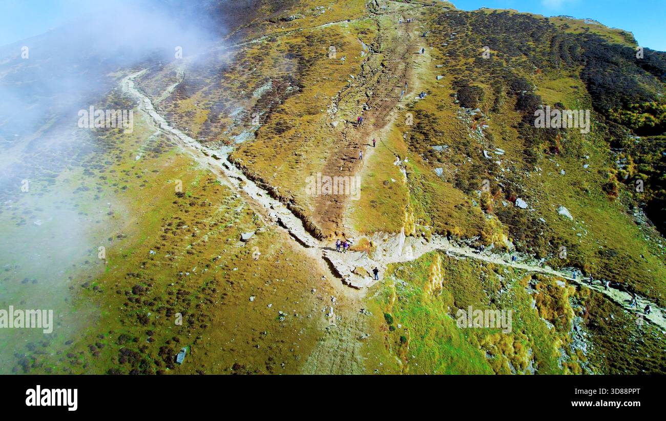 Aerial drone shot people devotees climbing narrow stair covered path of ...