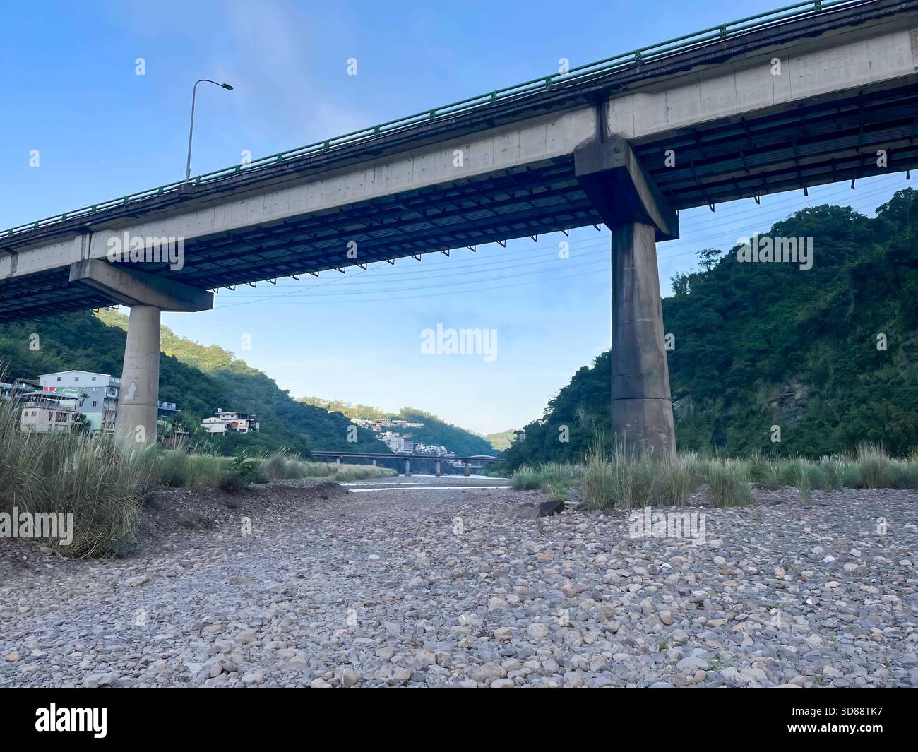 Looking up at the massive concrete structure of an elevated viaduct ...