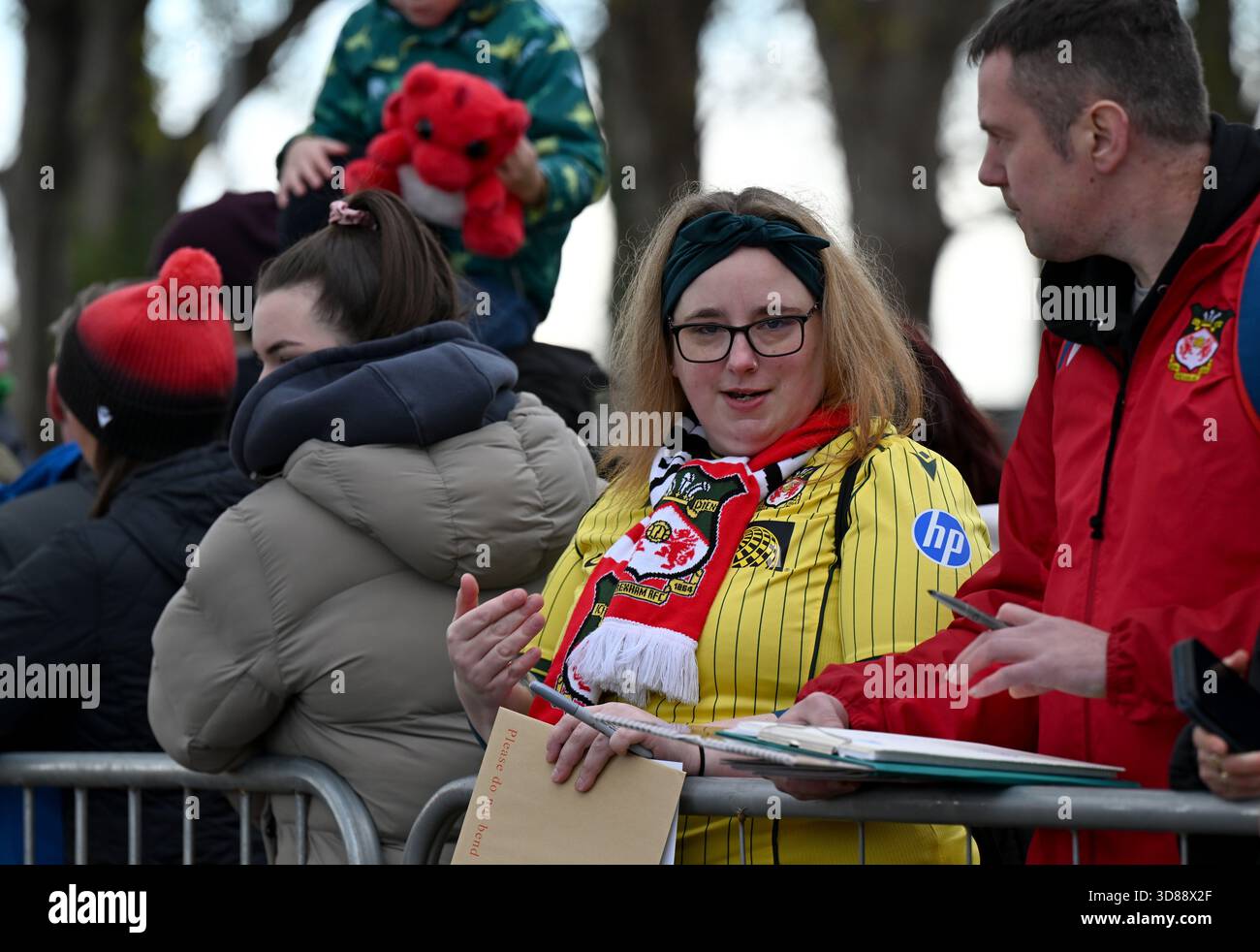 Wrexham fans wait for the players to arrive outside the ground ahead of ...