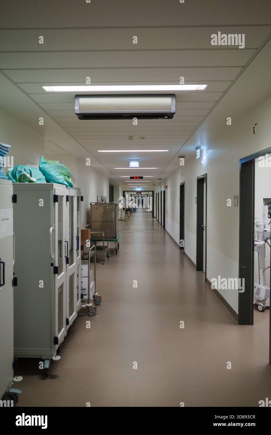Clean and brightly lit hospital corridor with medical equipment and ...