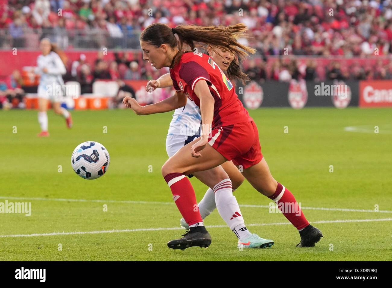 Canada's Holly Ward, front, takes the ball past Costa Rica's Gabriela ...