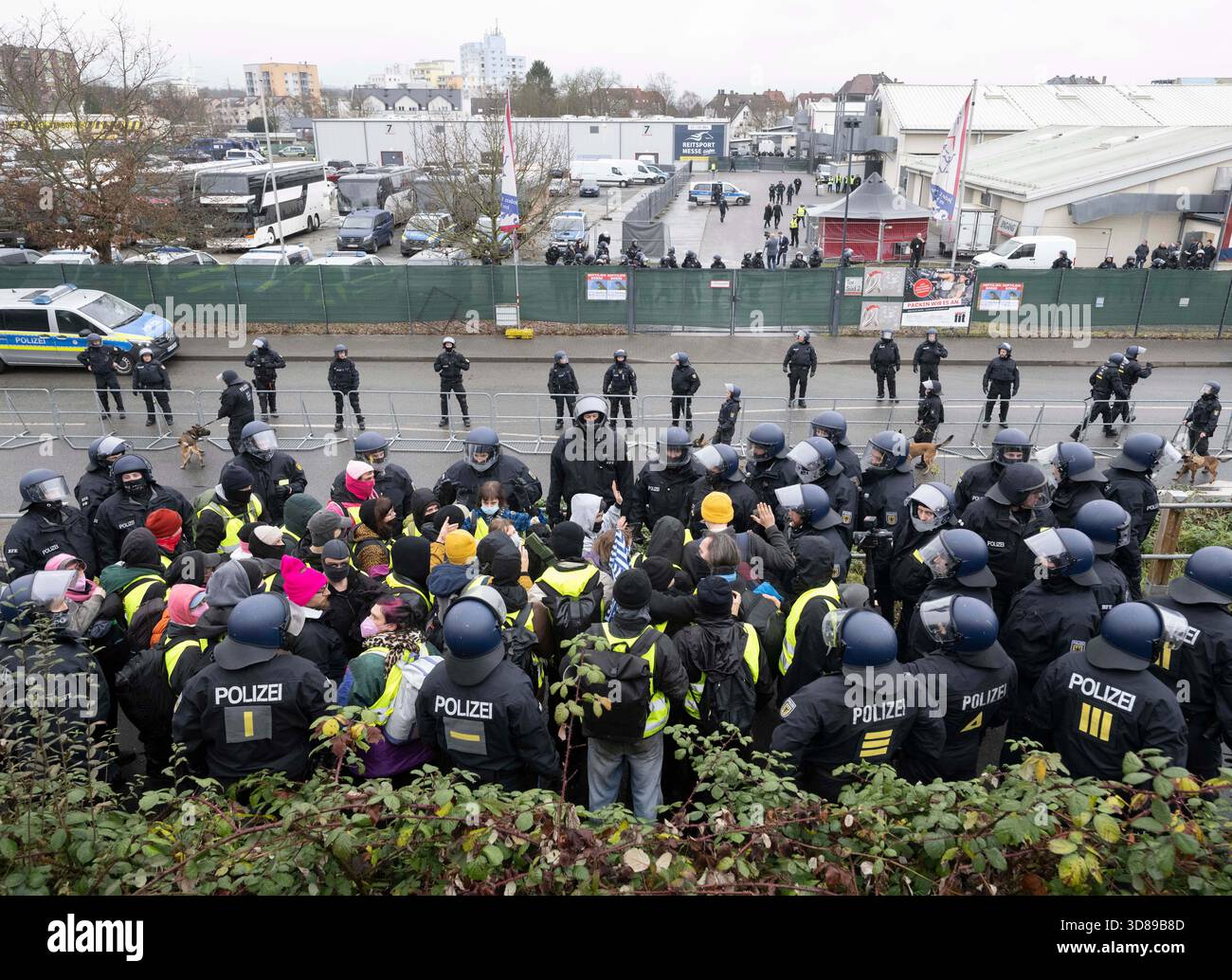 Police officers cordon off a group of demonstrators near the assembly ...