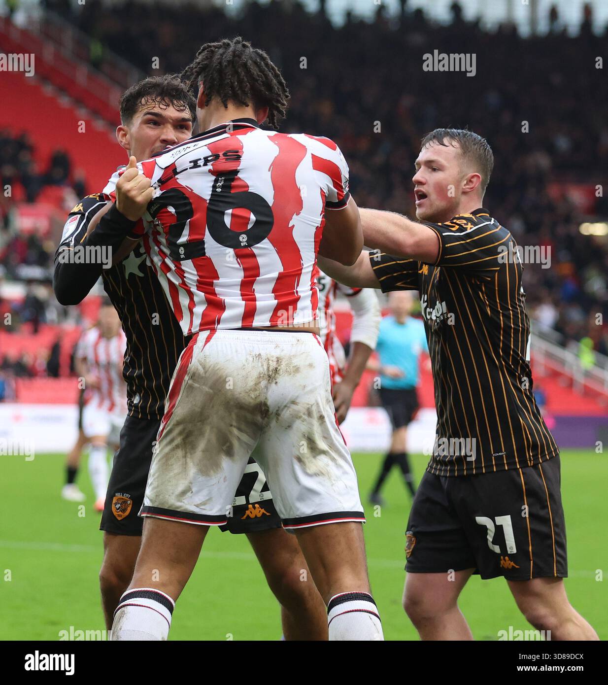 Stoke City's Ashley Phillips (centre) clashes with Hull City's Joe ...