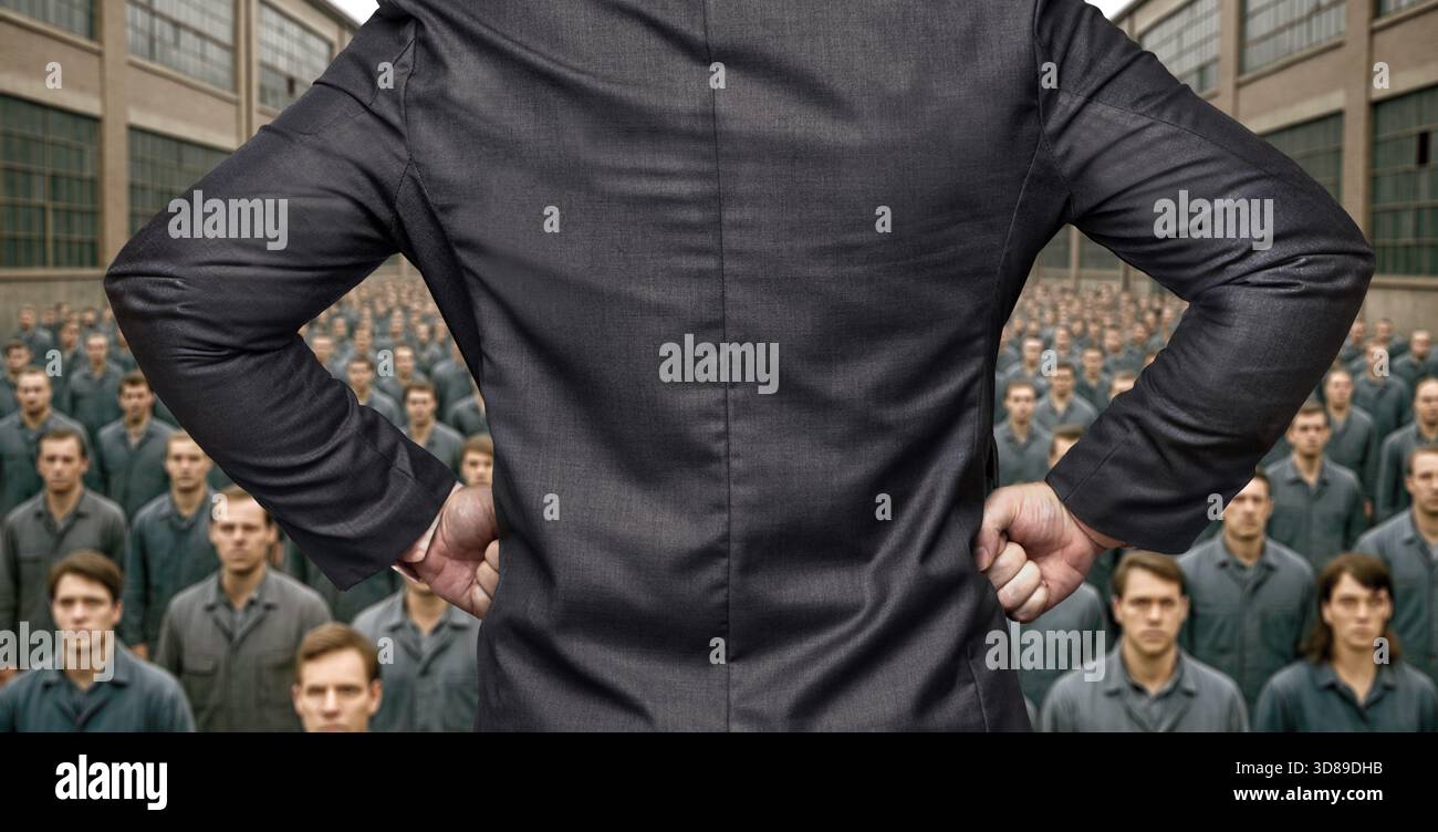 A confident suited leader stands with hands on hips, facing a large ...