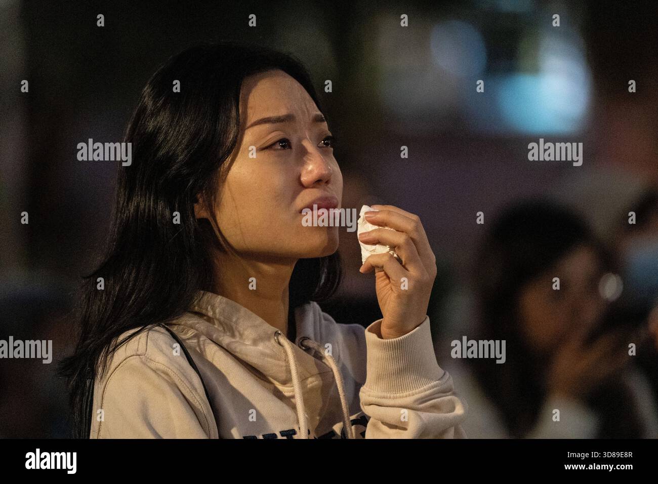 A woman crying near the scene of where a major fire engulfed several ...
