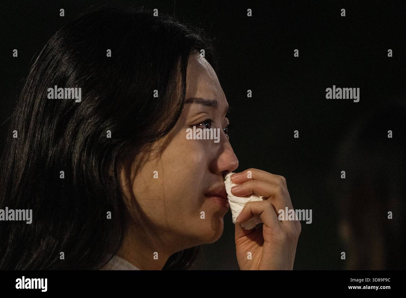 A woman crying near the scene of where a major fire engulfed several ...