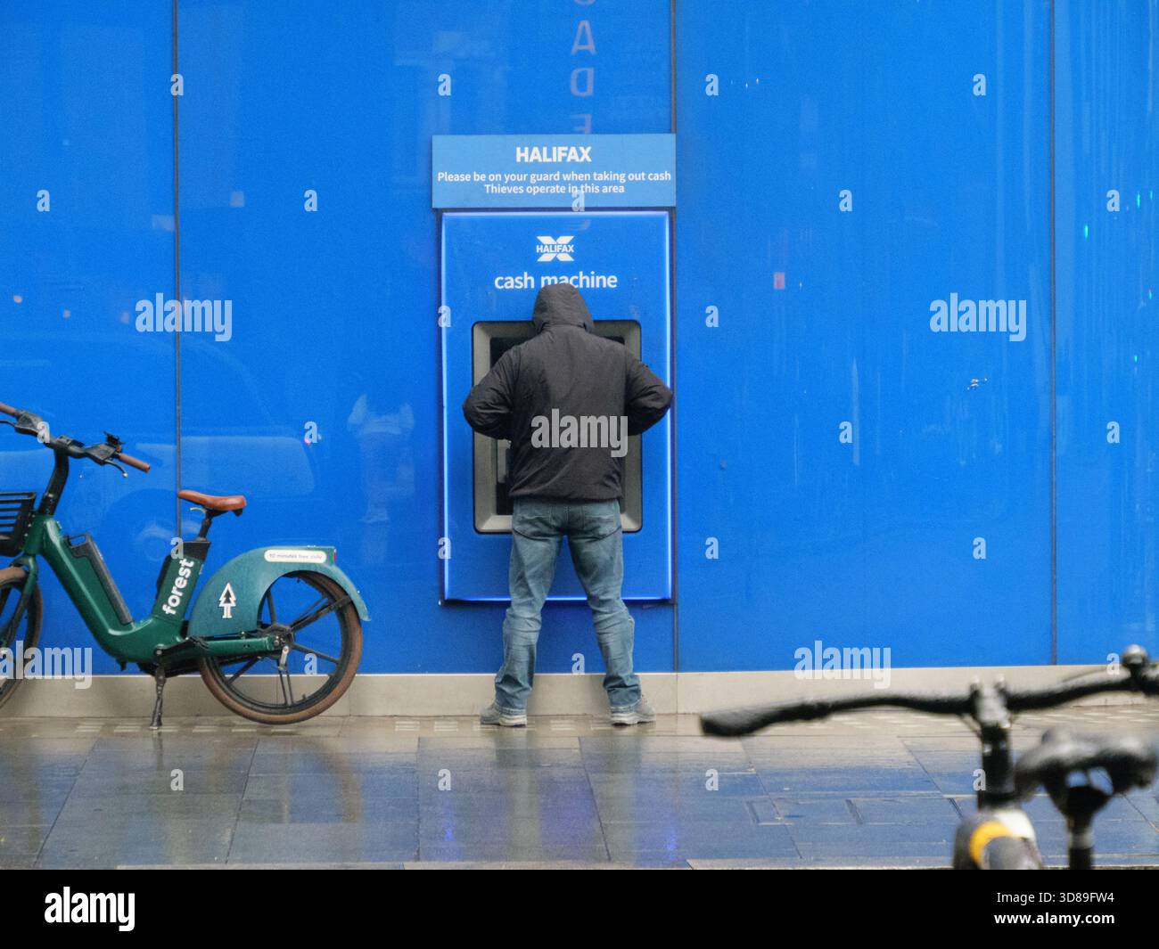 Using atm machine during everyday hi-res stock photography and images ...