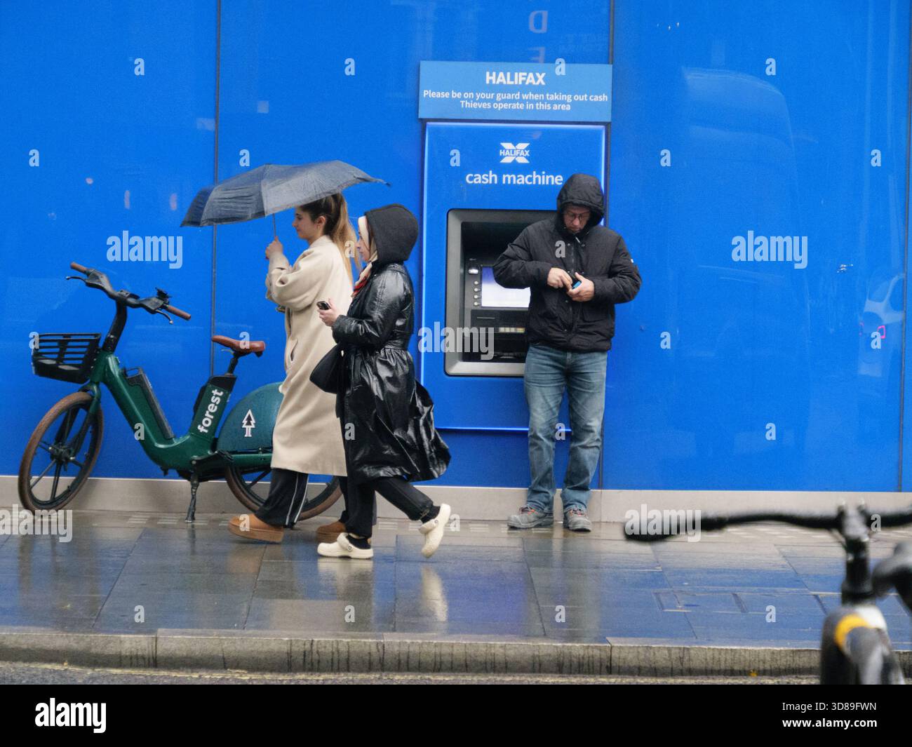 Using atm machine during everyday hi-res stock photography and images ...