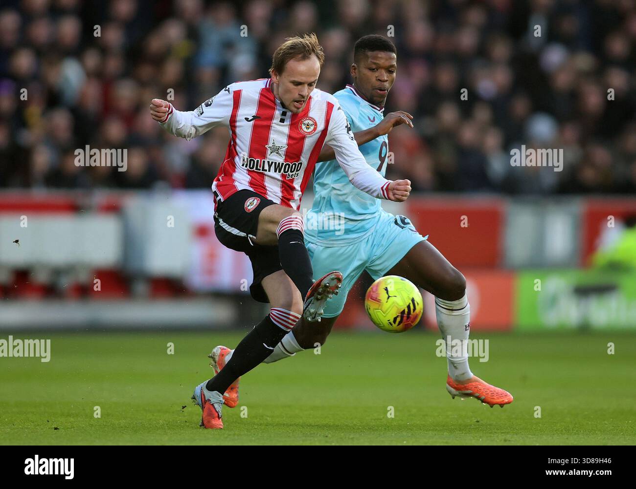 Brentford's Mikkel Damsgaard (left) and Burnley's Florentino Luis battle for the ball during the ...