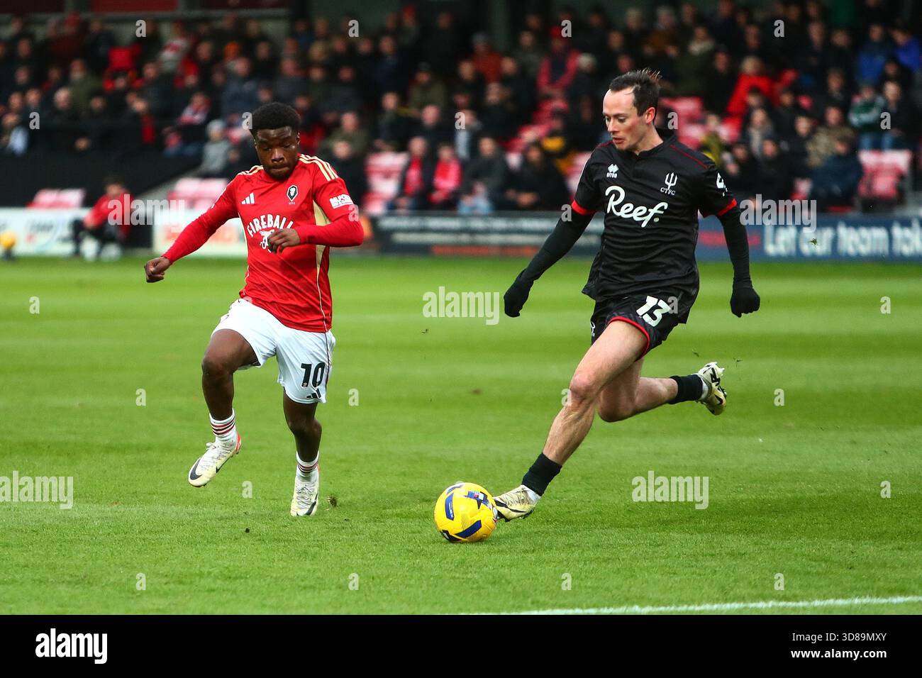 Harry McKirdy of Crawley Town battles with Kelly Nmai of Salford City ...
