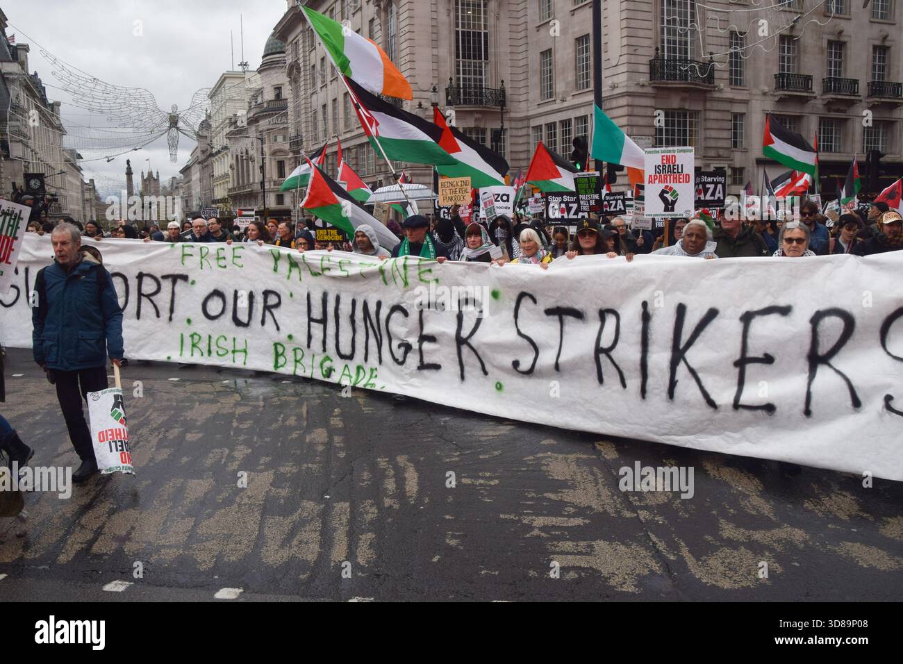 London, UK. 29th November 2025. Protesters hold a banner in support of ...