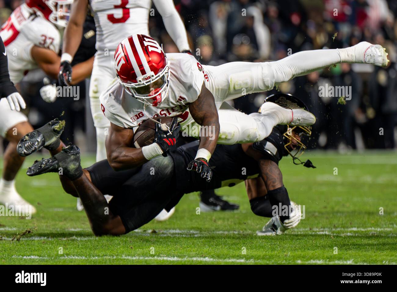 Indiana running back Kaelon Black (8) is tripped up by a Purdue ...