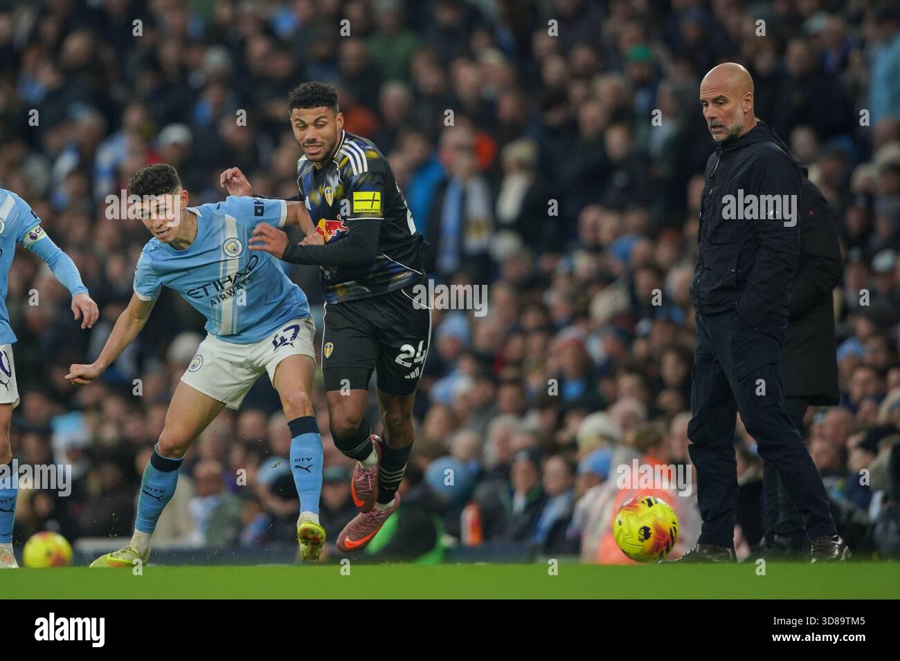 Manchester City's head coach Pep Guardiola, right, looks on as Leeds ...