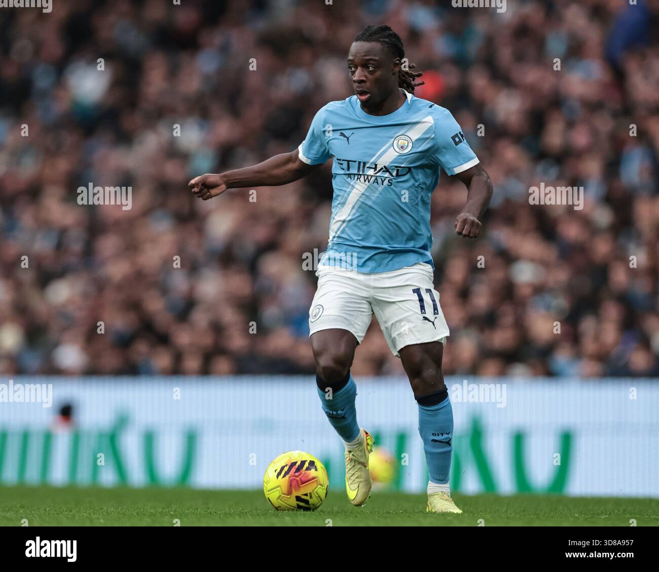 Jeremy Doku of Manchester City breaks with the ball during the Premier ...
