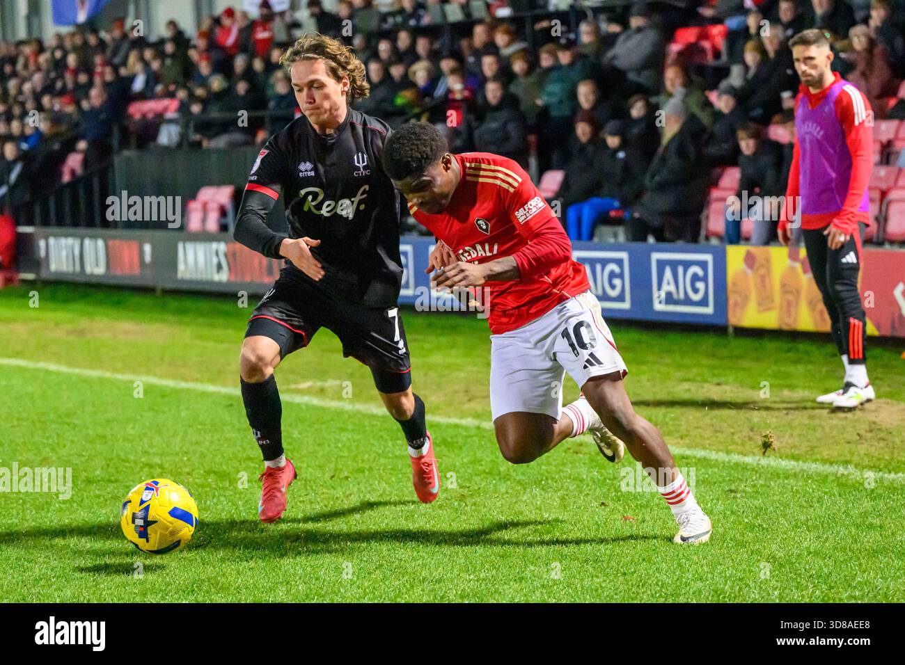 Harry Forster of Crawley Town tackles Kelly Nmai of Salford City FC ...
