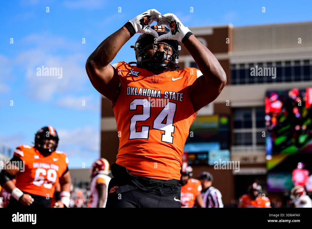 Oklahoma State running back Trent Howland (24) gestures against Iowa State during the first half ...