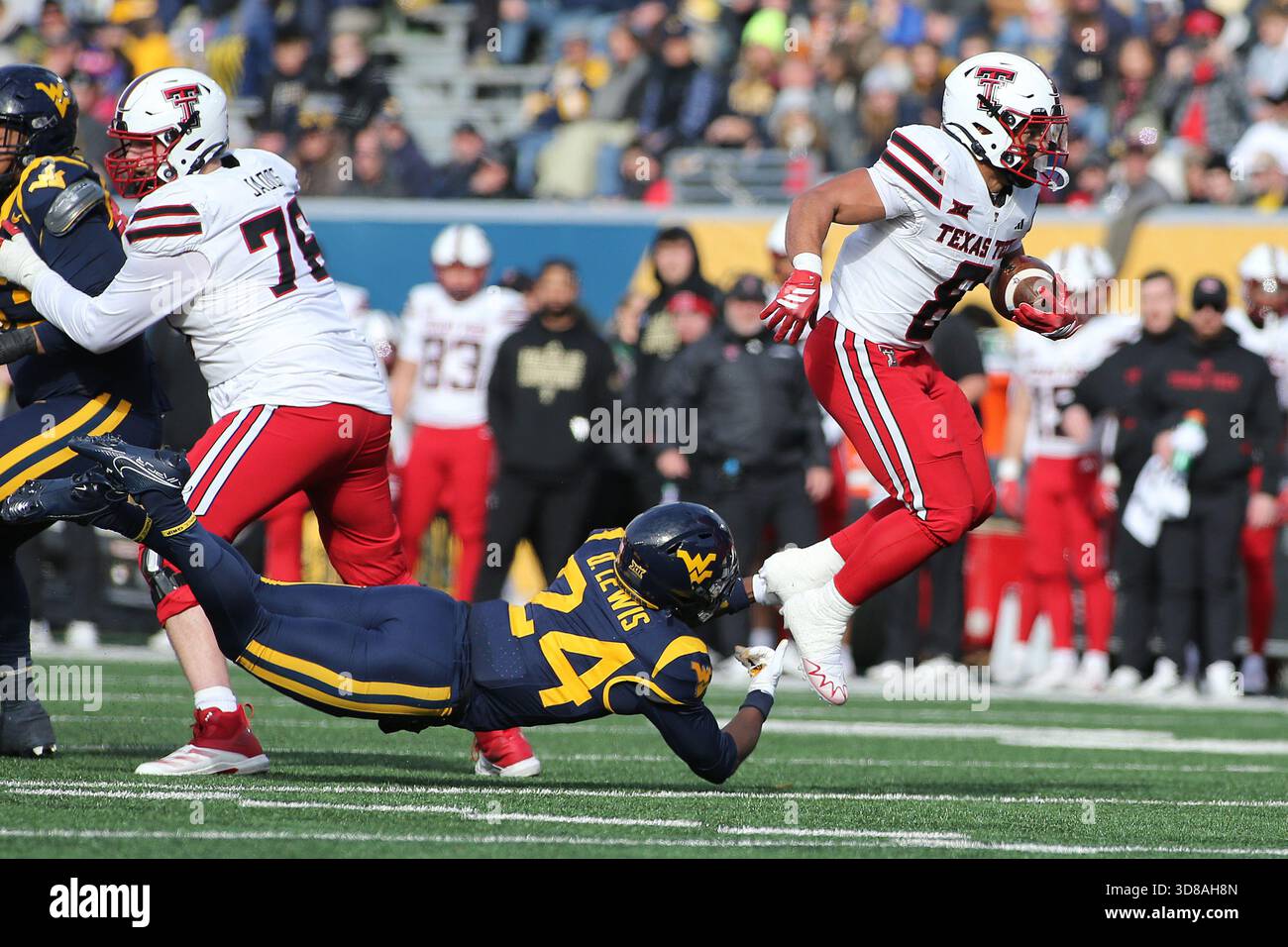 Texas Tech running back Cameron Dickey (8) is defended by West Virginia ...