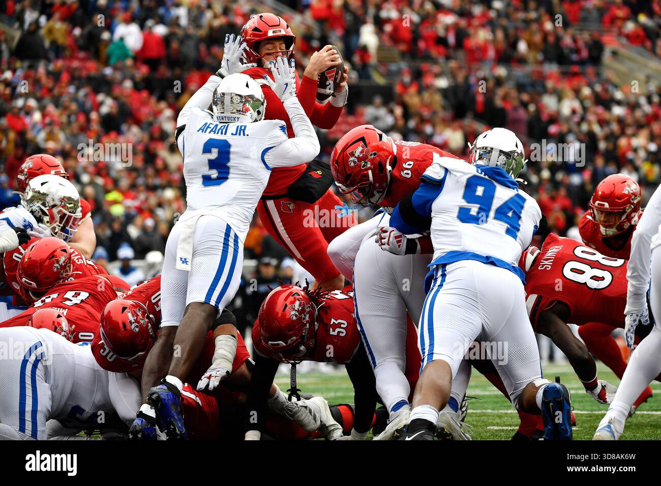 Louisville quarterback Miller Moss (7) dives over the Kentucky line to ...