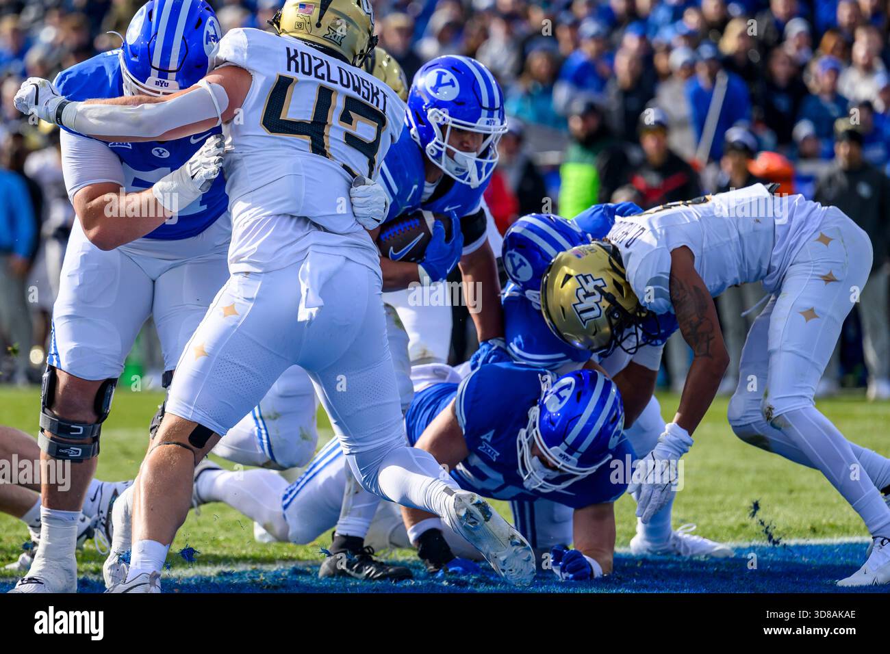 BYU running back LJ Martin, center, runs the ball into the end zone ...