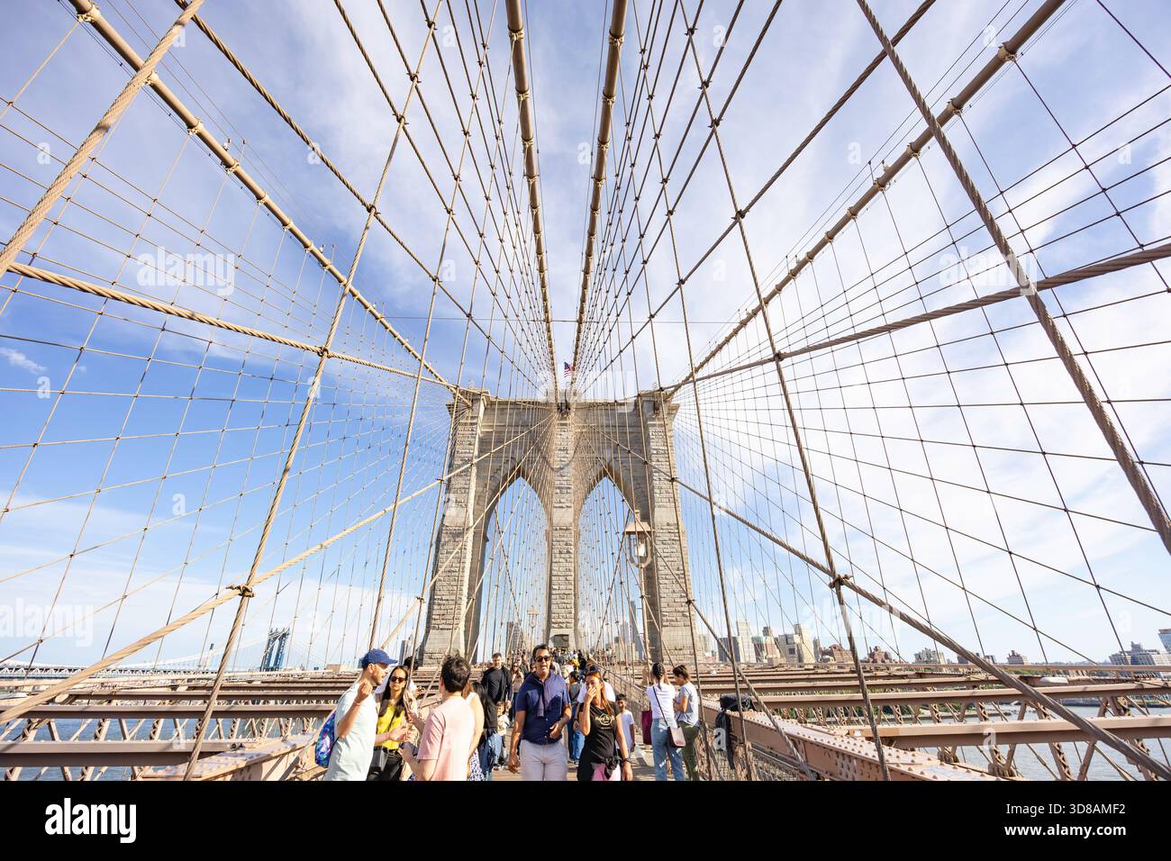 The pedestrian section of the Brooklyn Bridge in New York City is full ...