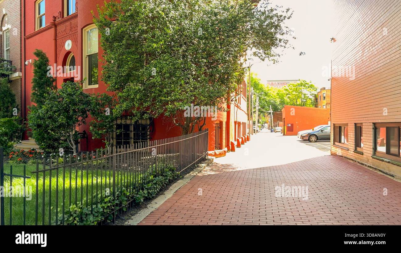 Washington D.C. USA - May 24, 2025. A quiet brick alley beside red ...