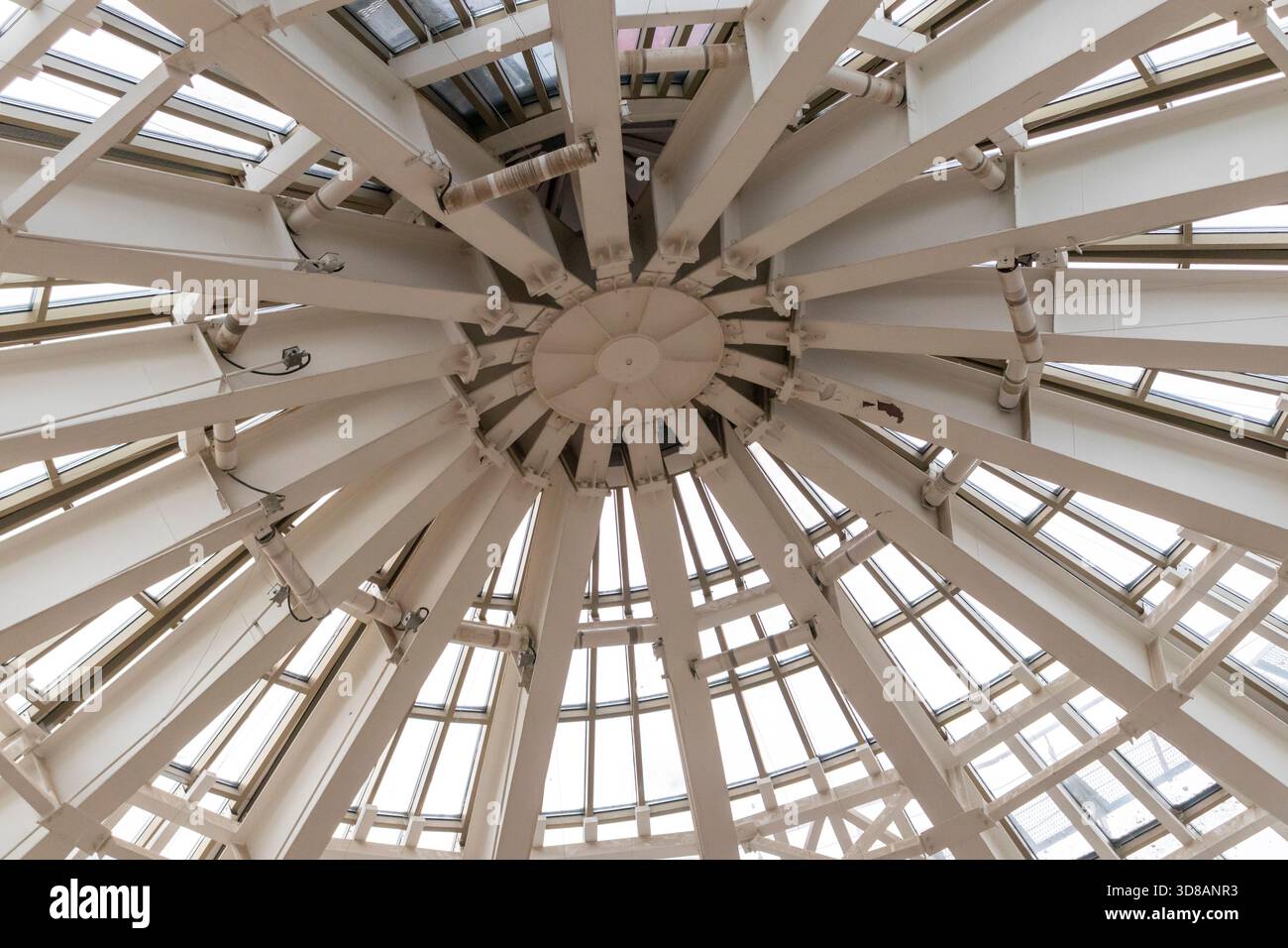 The photograph displays the interior structure of a large architectural ...