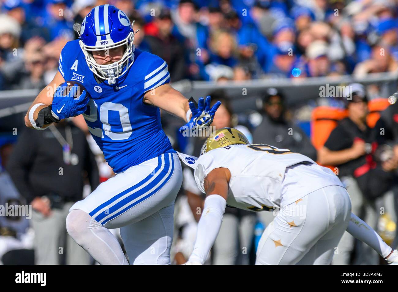 BYU tight end Carsen Ryan, left, runs the ball after a catch as UCF ...