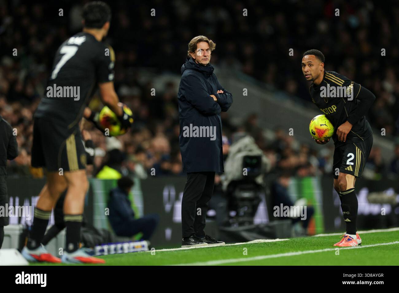 Tottenham's head coach Thomas Frank, center, stands on the touchline ...