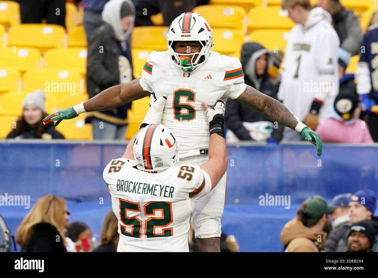 Miami running back Charmar Brown (6) celebrates with James Brockermeyer ...