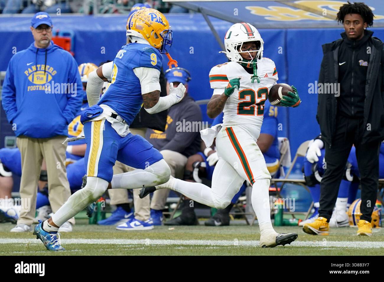 Miami running back Girard Pringle Jr. (22) carries as he's defended by ...