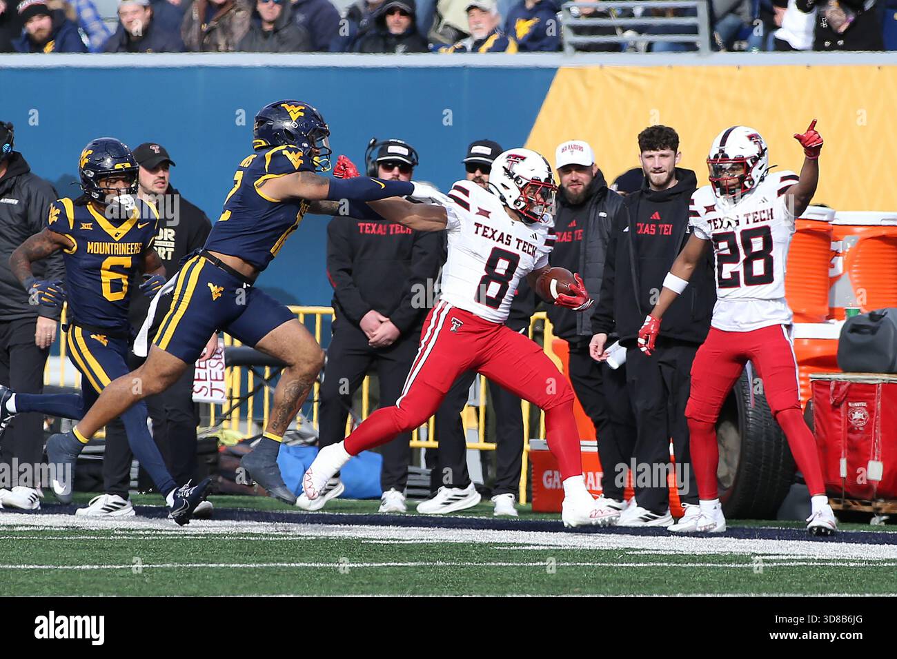 Texas Tech running back Cameron Dickey (8) is defended by West Virginia ...