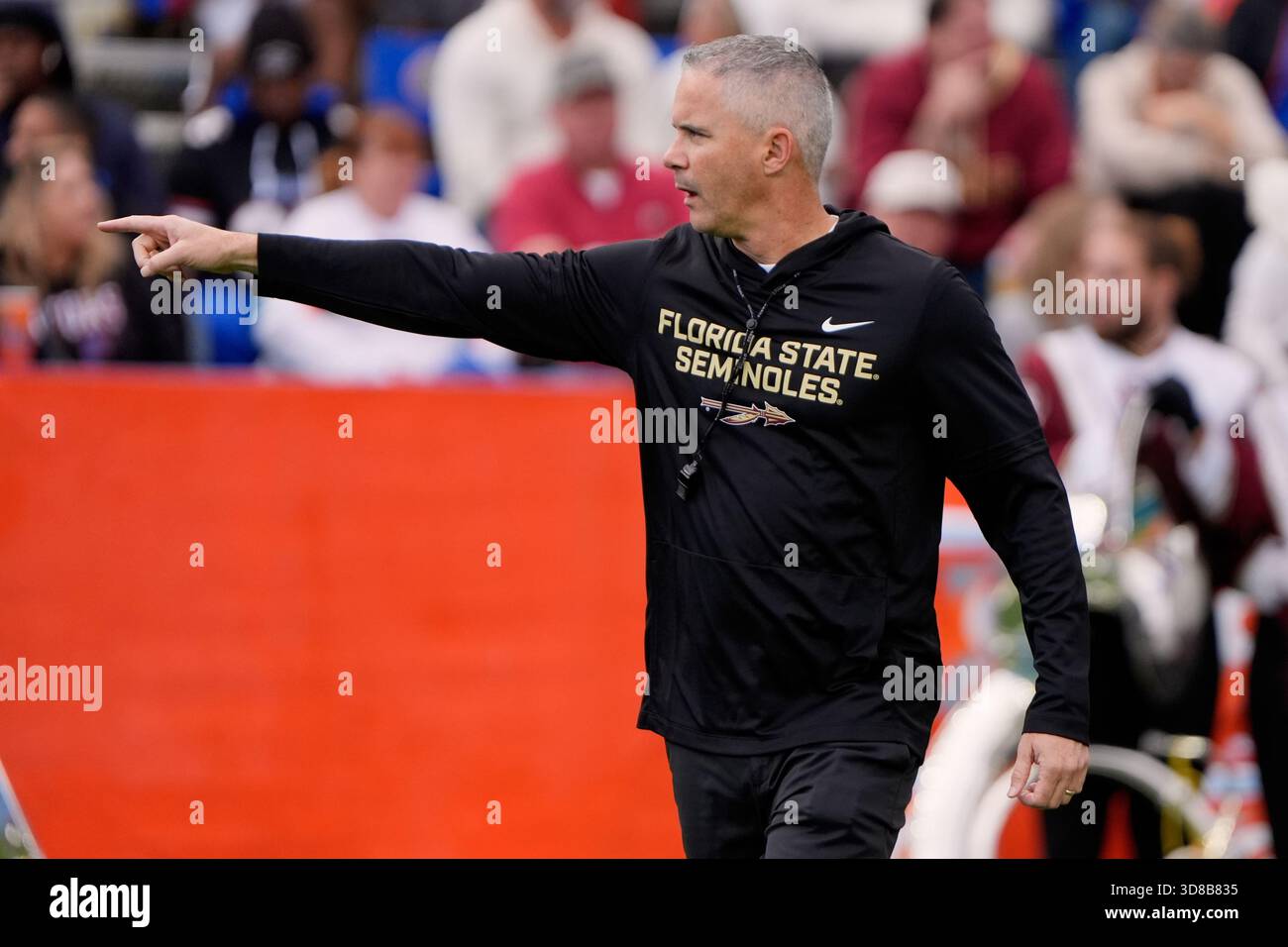 Florida State head coach Mike Norvell directs players during warm ups ...