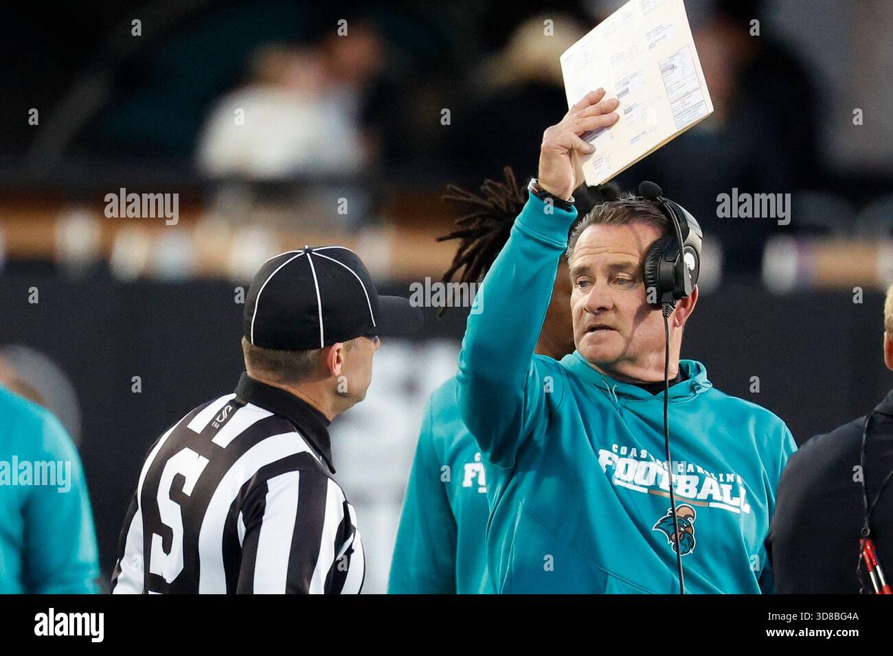 Coastal Carolina head coach Tim Beck, right, argues a call with side ...